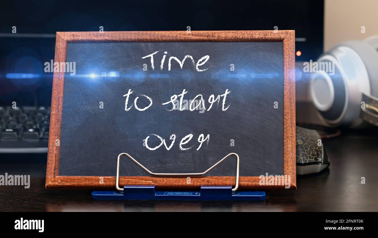 TIME TO START OVER message on the black styling board on the workplace ...