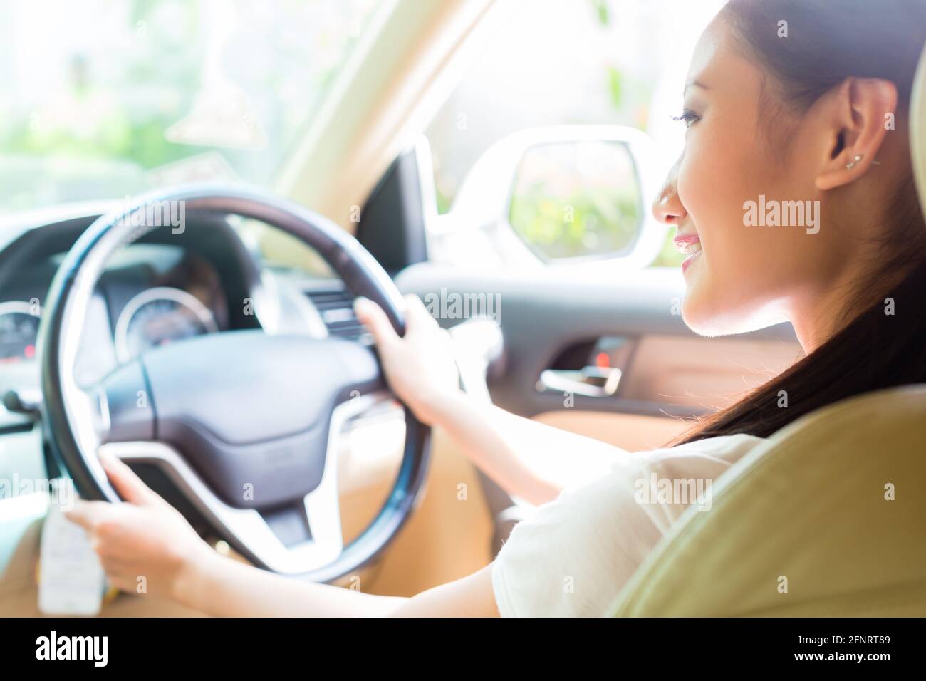 Asian woman driving new car Stock Photo - Alamy