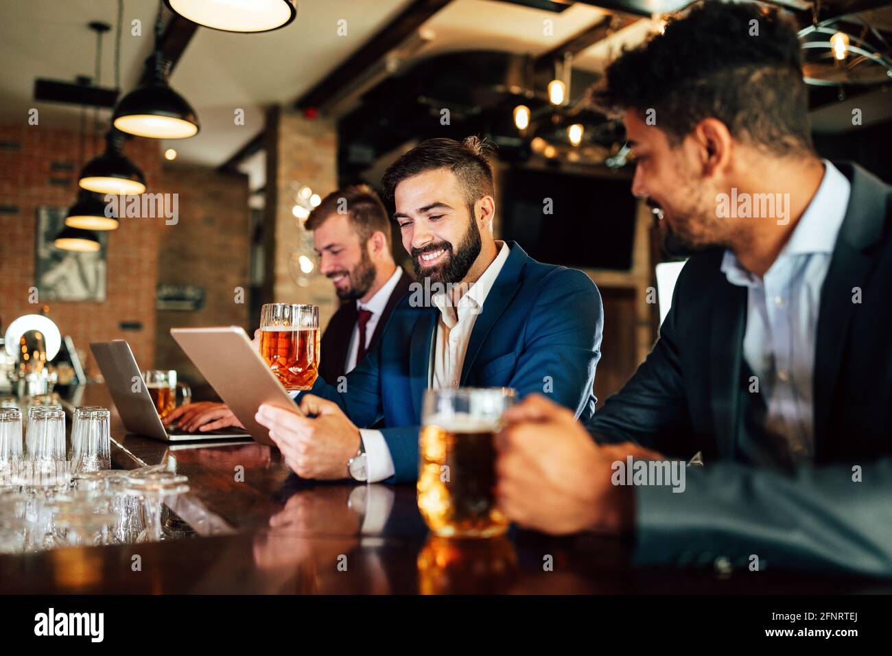 Meeting with the best friends. Happy young business men talking and ...