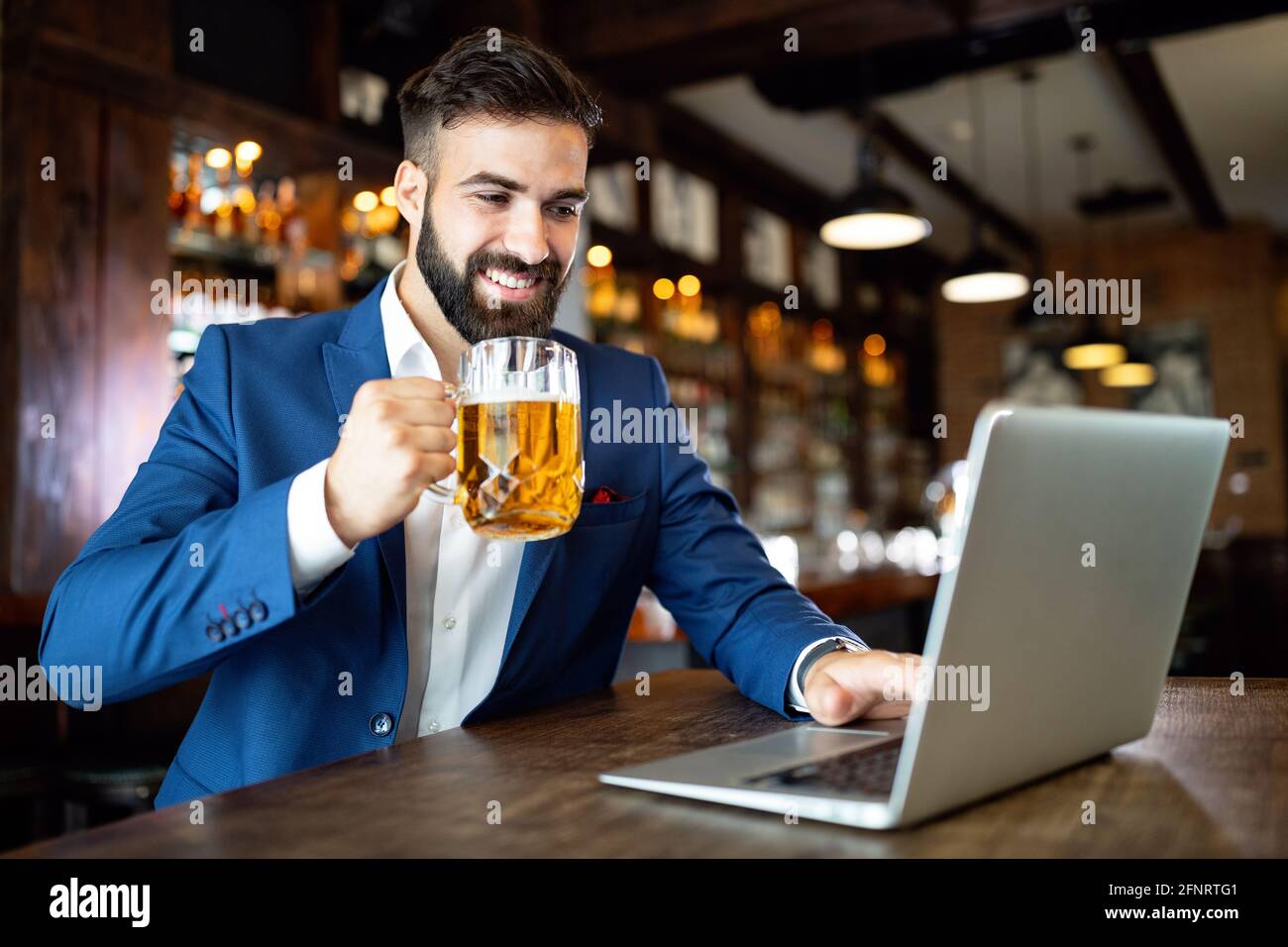 Happy friends raising beer hi-res stock photography and images - Alamy