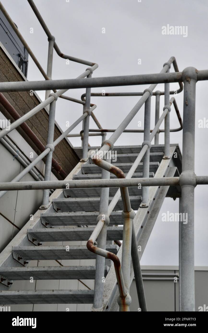 Set of metal or steel safety access steps or stairs on an industrial ...