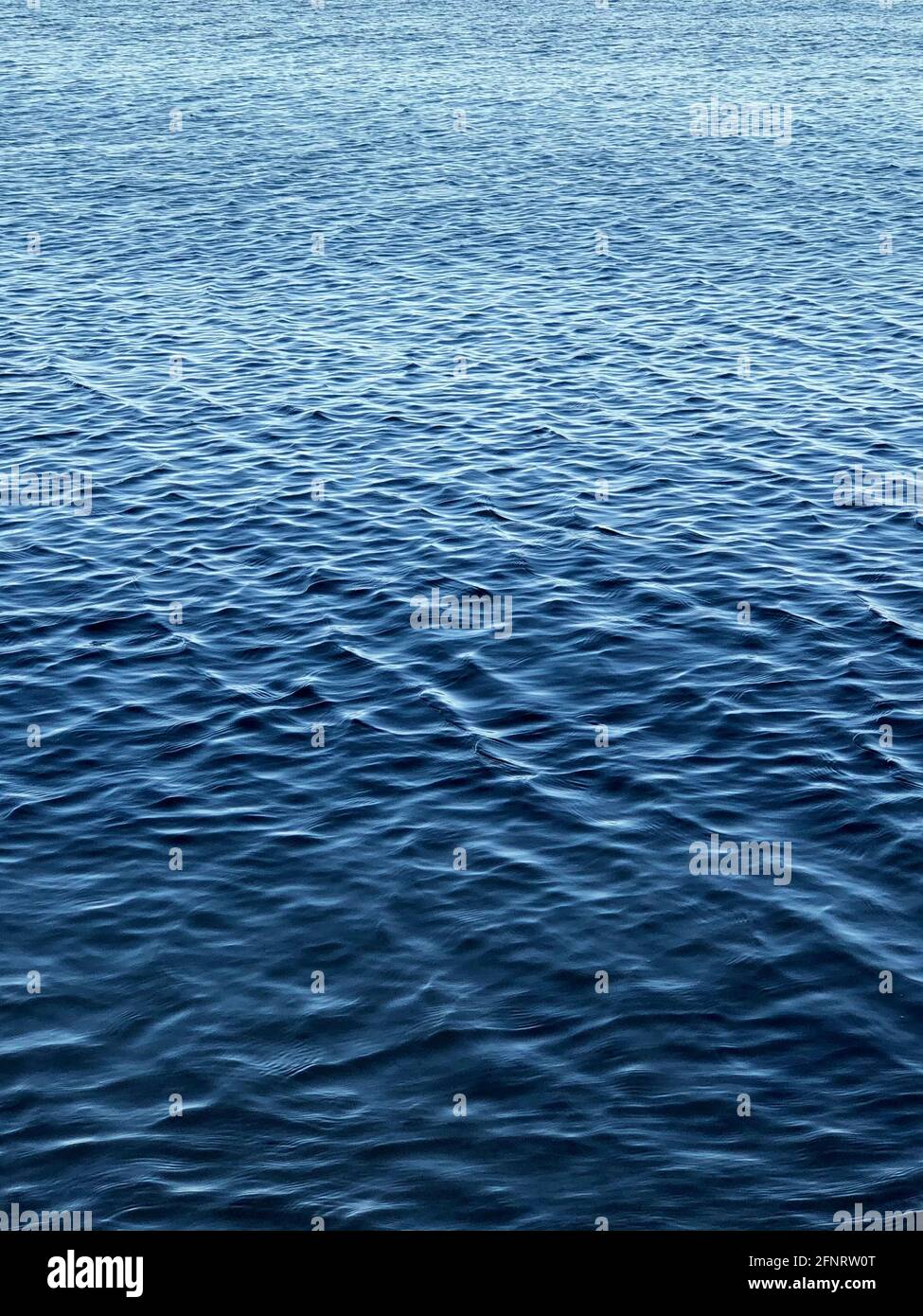 Background photo of blue ocean water in the summer Stock Photo - Alamy