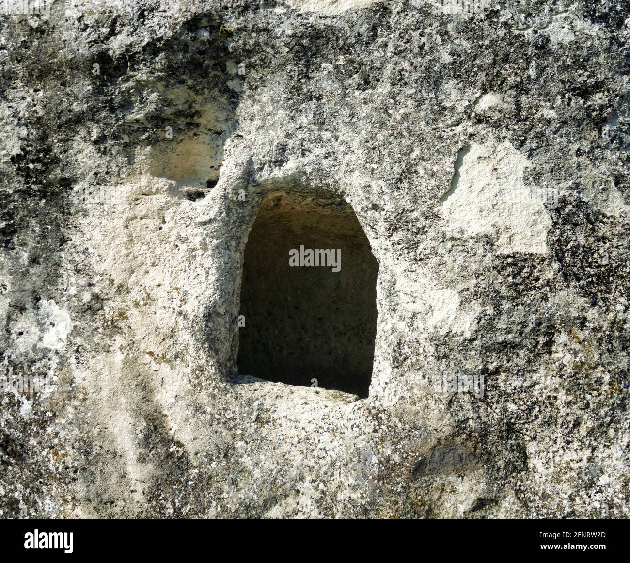 Entrance to a man-made cave in a limestone rock. A place of refuge for ...