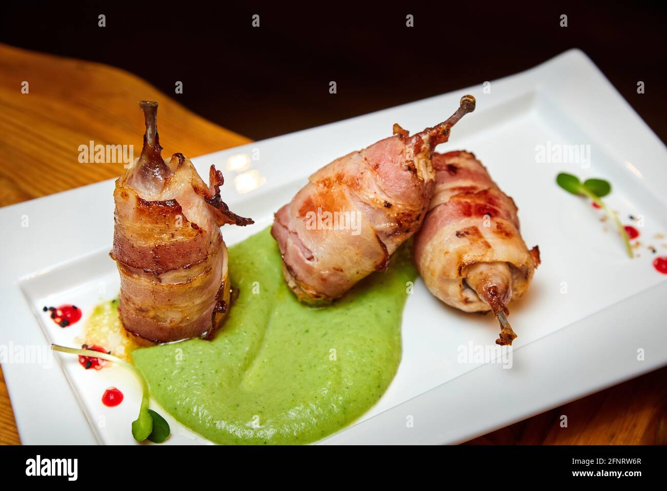 Quail mousse in bacon and broccoli puree. Close-up, selective focus ...