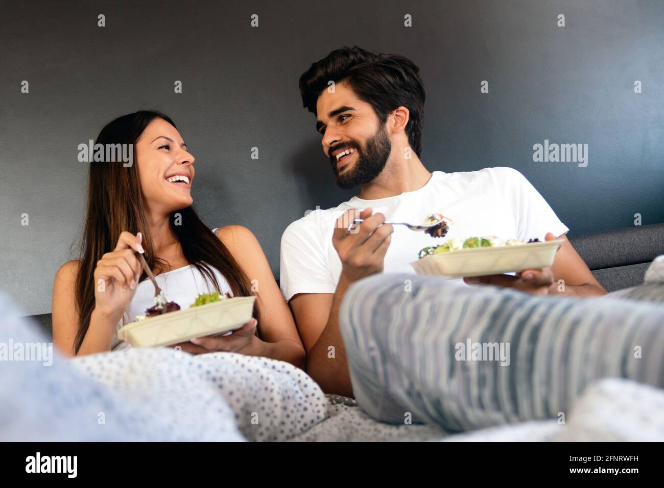 Couple in love having breakfast in bed. People, love, food concept ...