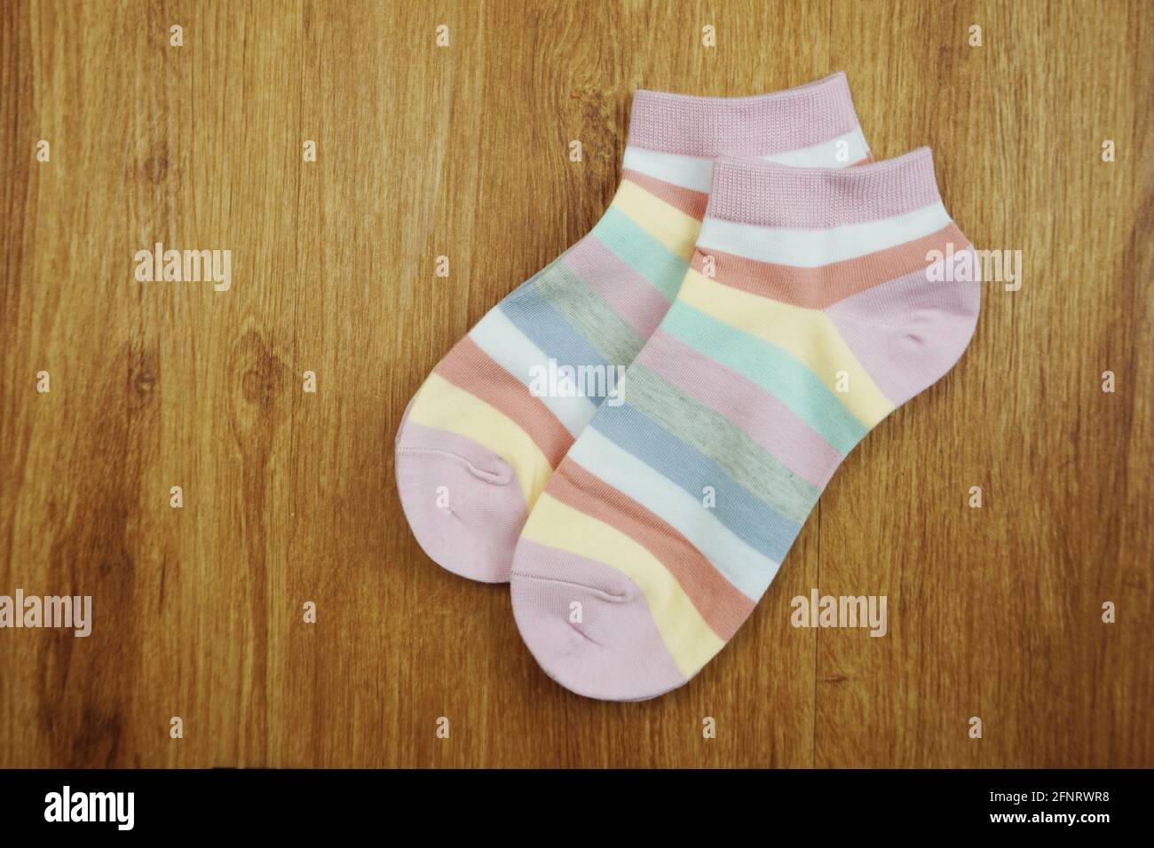 colorful pastel socks on wooden background Stock Photo - Alamy