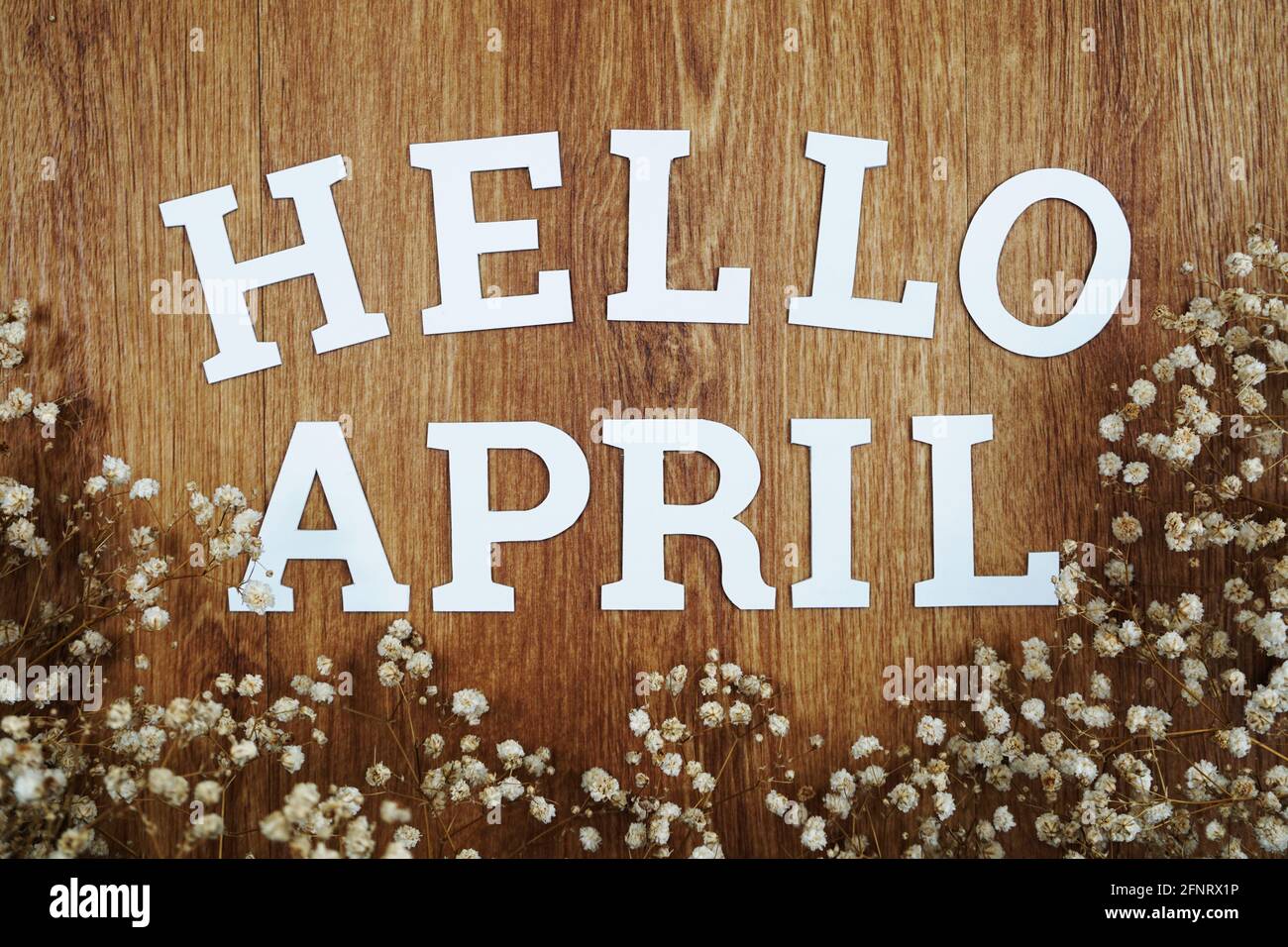 Hello April Alphabet Letters with dried flower on wooden background ...