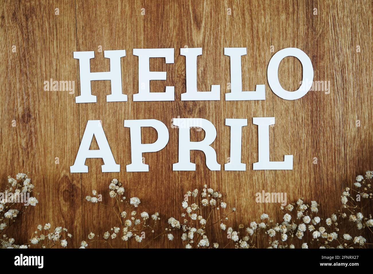 Hello April Alphabet Letters with dried flower on wooden background ...