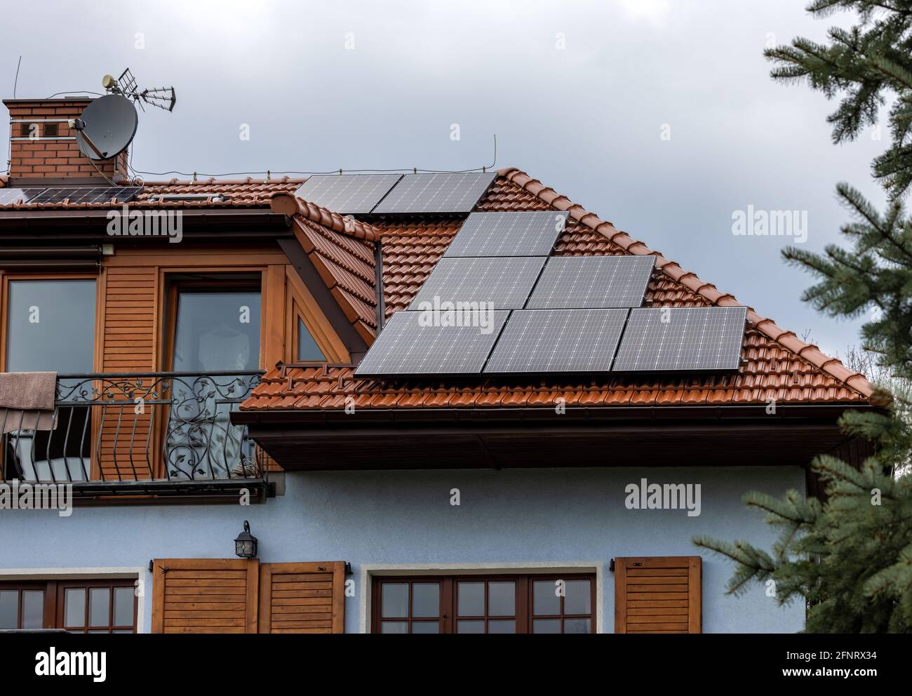 Solar electric panels on a house roof Stock Photo - Alamy