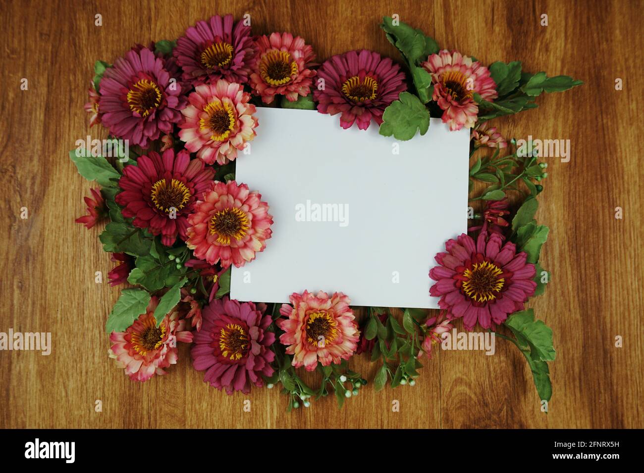 Flat lay of flowers and space copy on wooden background Stock Photo - Alamy