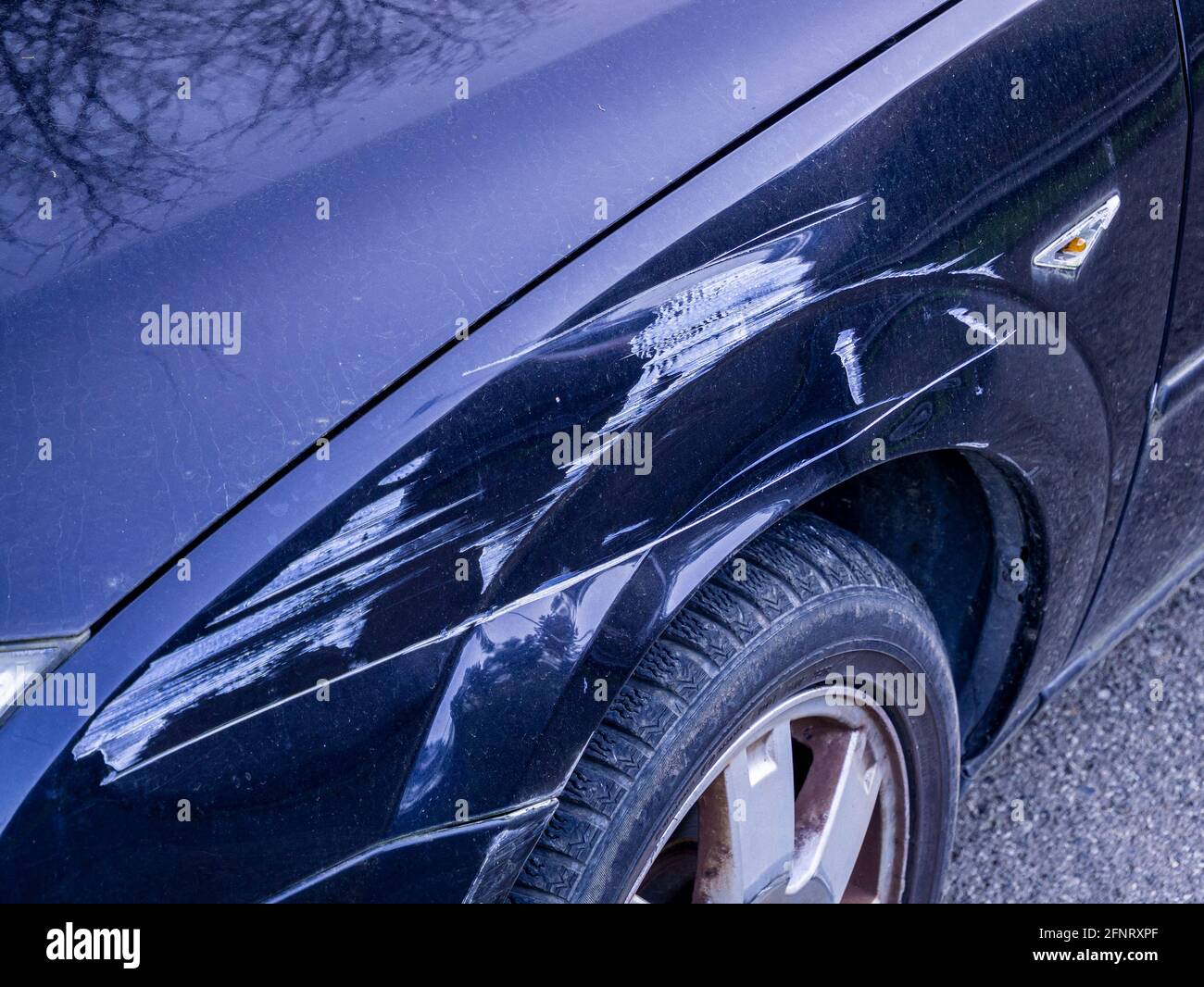Black car with a damaged side above the wheel Stock Photo - Alamy