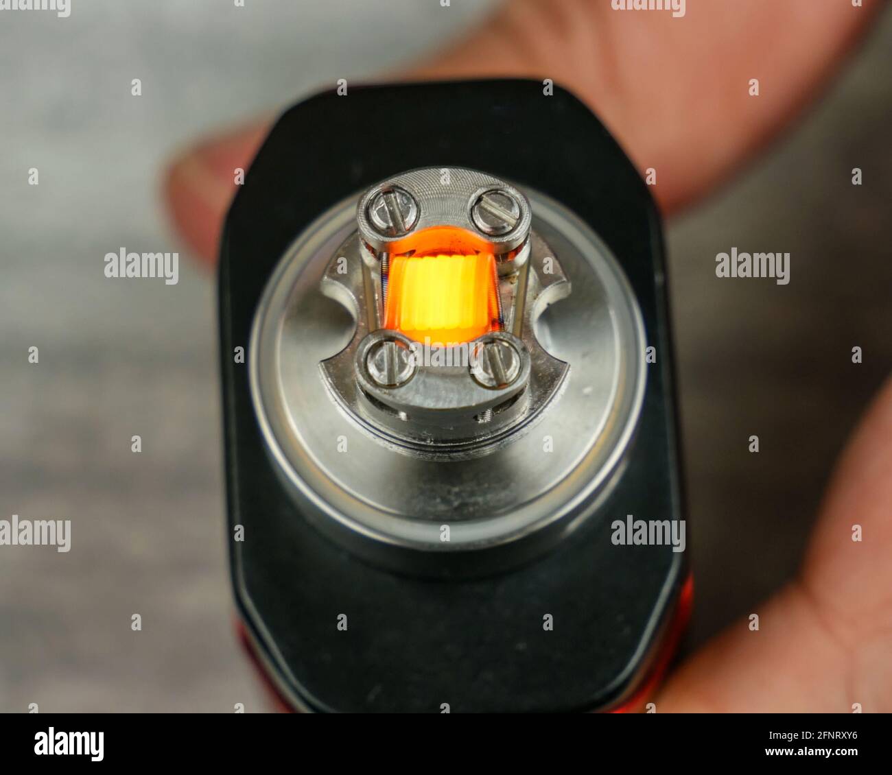 Brightly glowing coil in the atomizer for vaping Stock Photo - Alamy