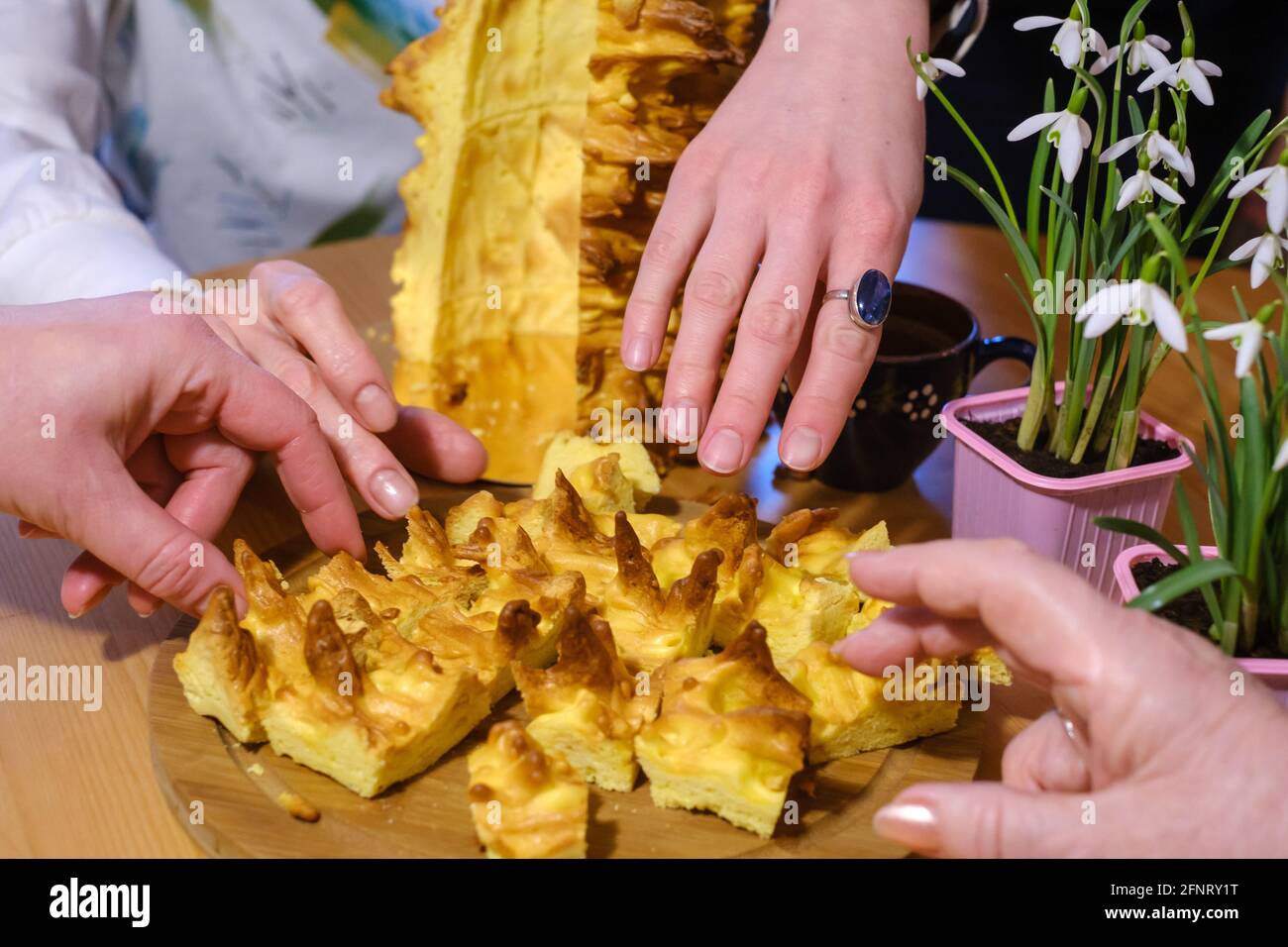 Crop people eating tasty sakotis cake Stock Photo - Alamy