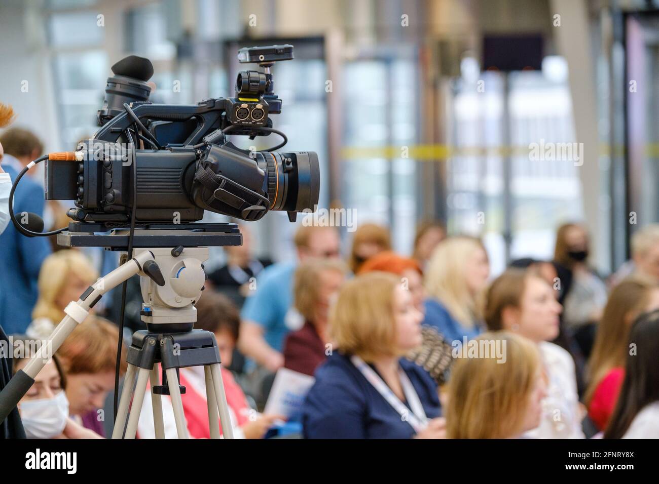 Crop videographer recording video during business seminar Stock Photo ...