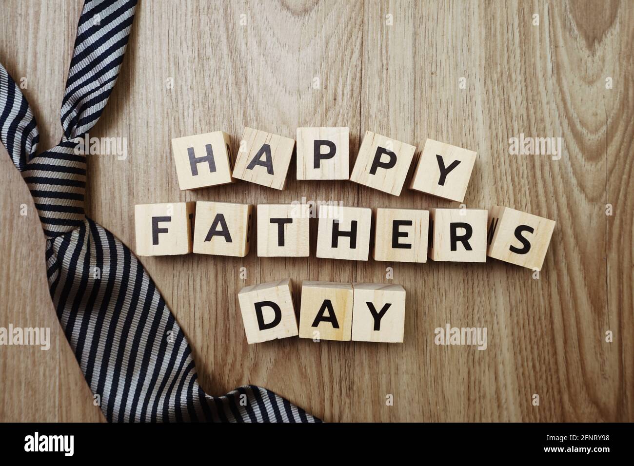 Happy Father's Day alphabet letters with necktie on wooden background ...