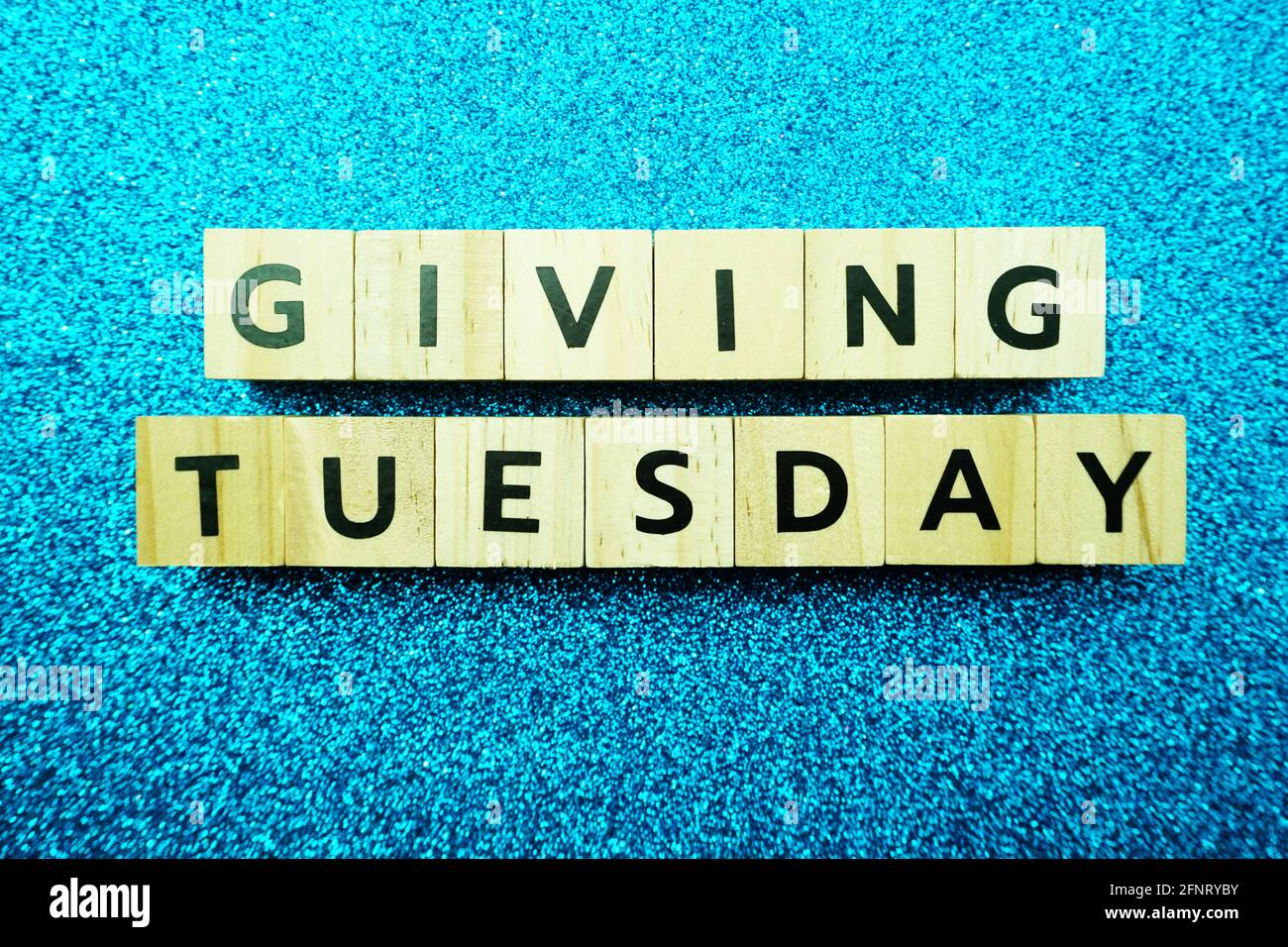 Giving Tuesday alphabet letter on blue glitter background Stock Photo ...