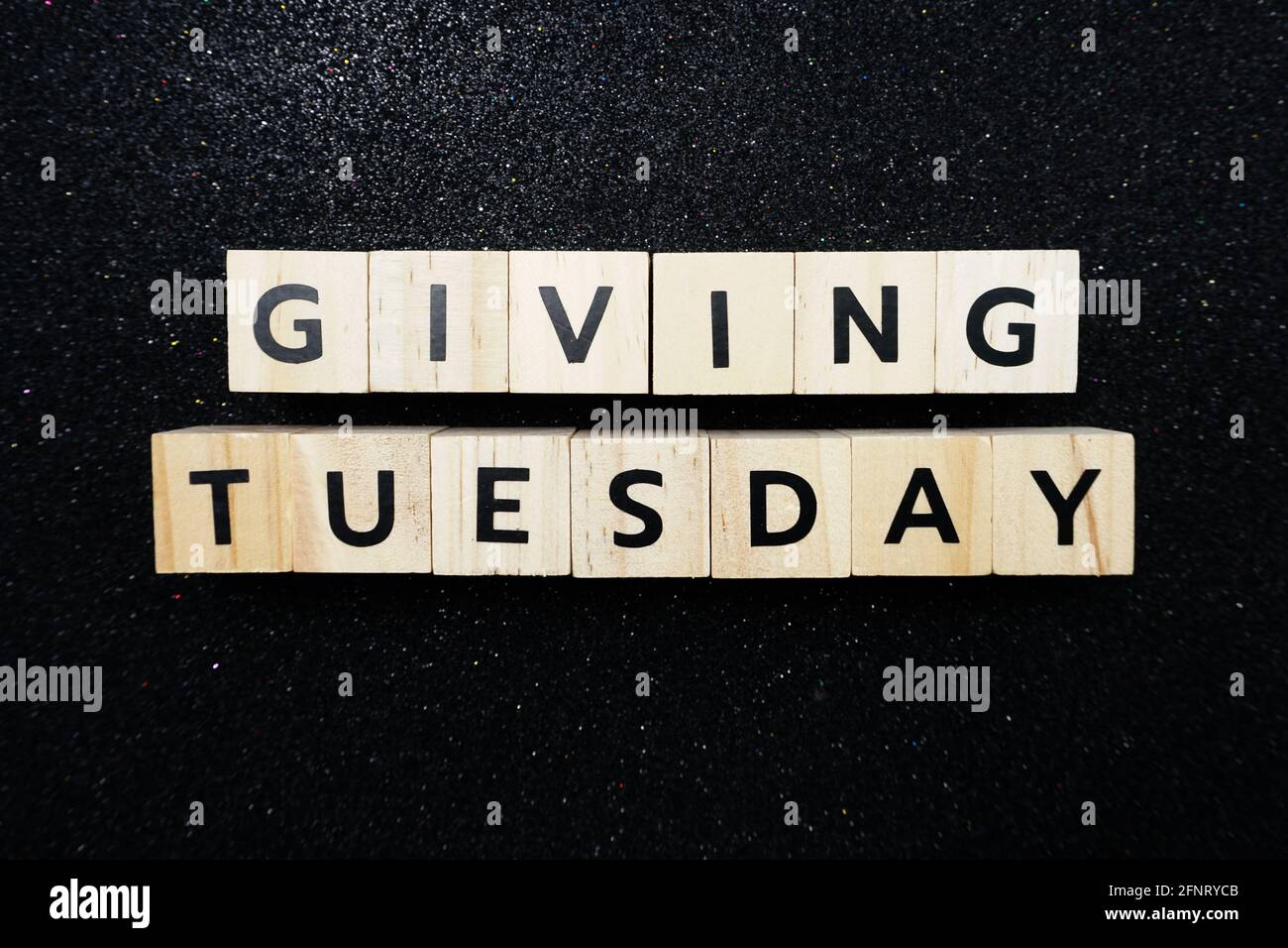 Giving Tuesday alphabet letter on black glitter background Stock Photo ...
