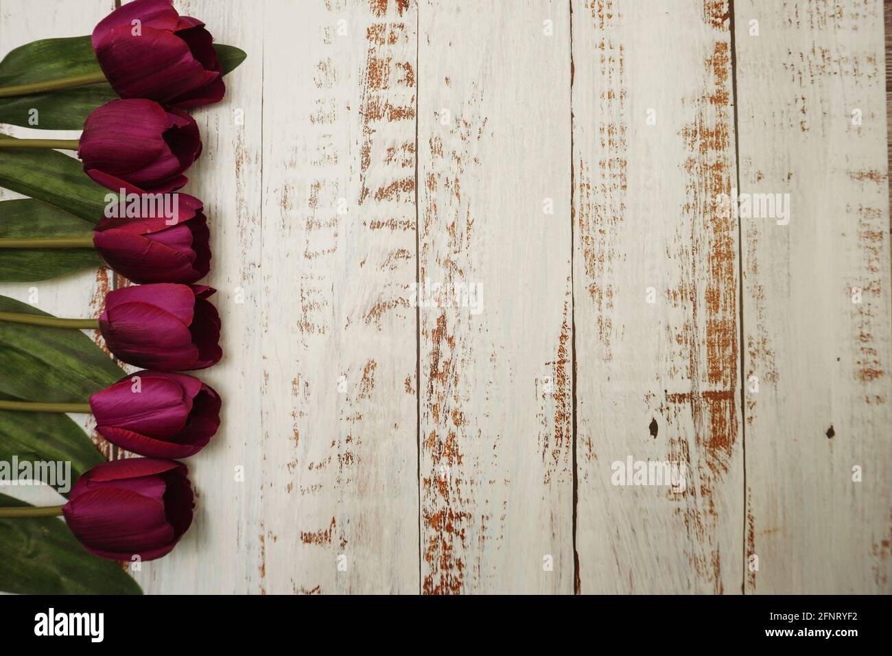 Purple Tulips bouquet with Space for texton a wooden background Stock ...