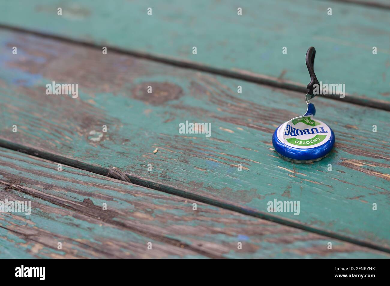 Ring pull beer cap Tuborg Green. A beer cork lies on a wooden surface ...