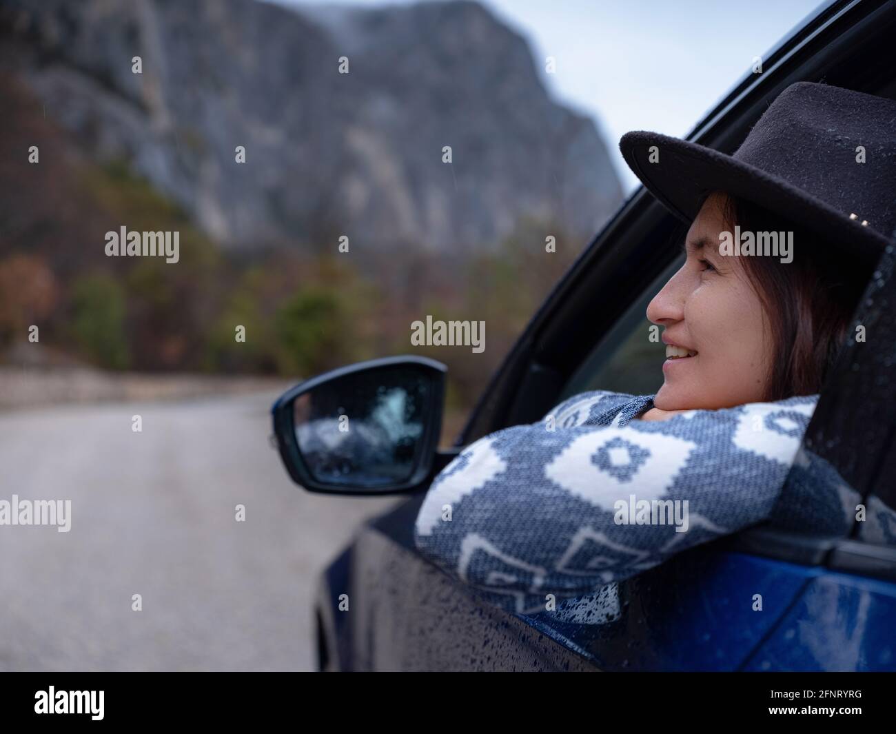 Asian young hipster woman traveling on car vacation. Autumn drive. The ...
