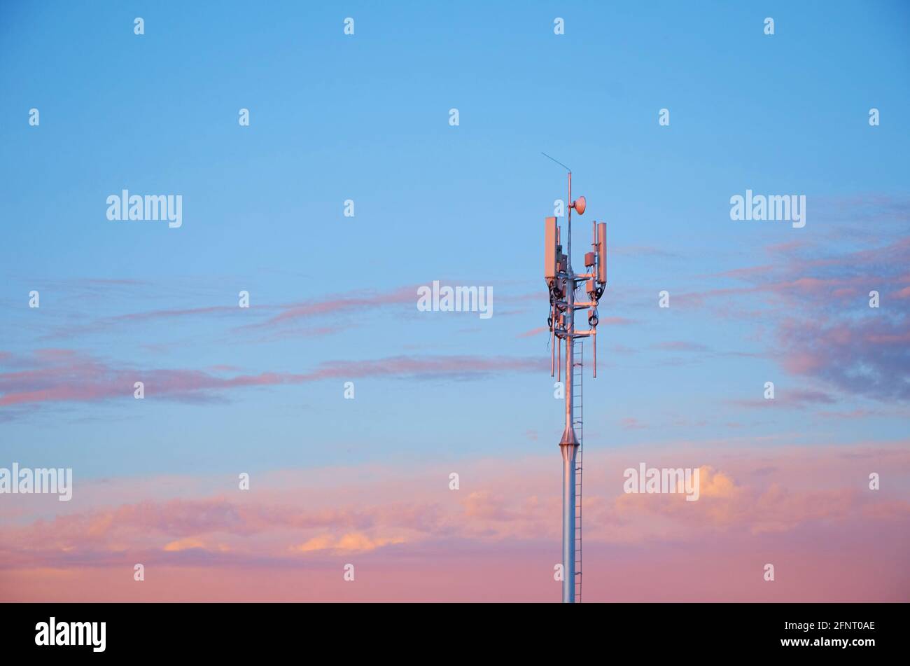 Cell tower on the background of the sunset sky with clouds Stock Photo ...