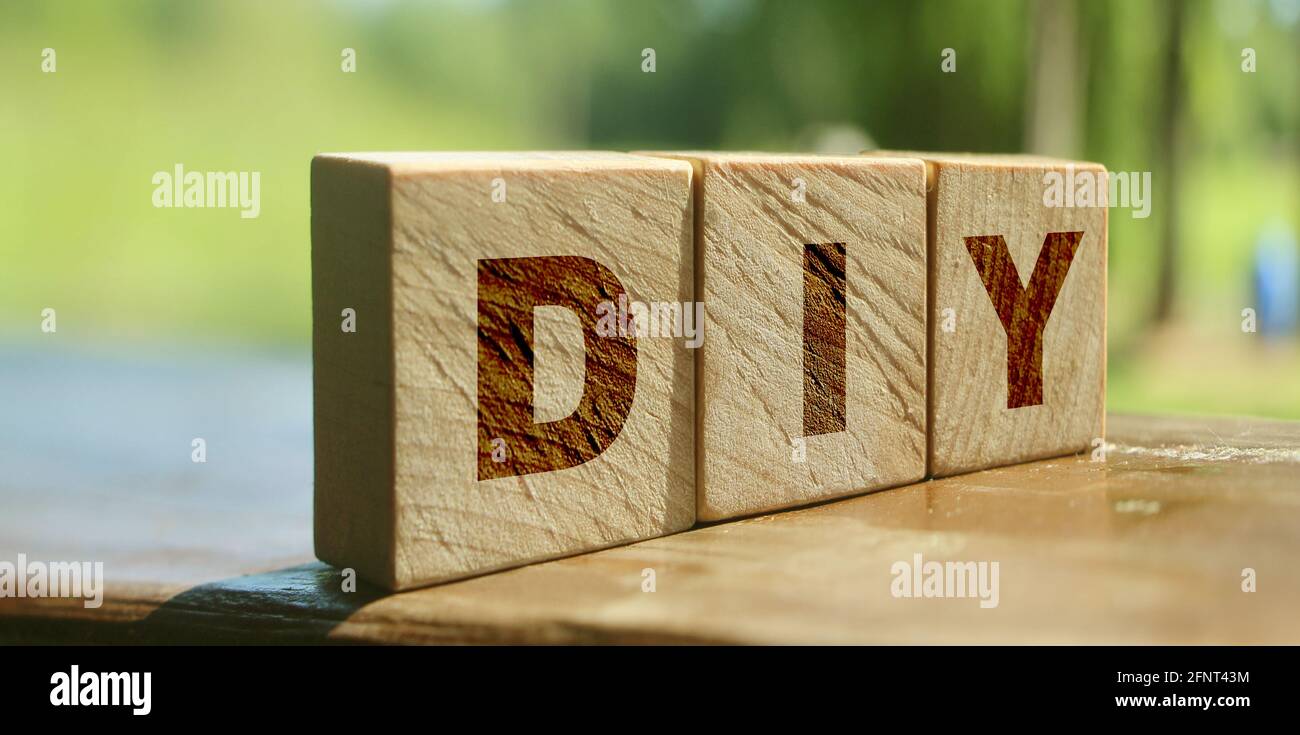 Wood cube blocks with letters DIY on red background. business concept ...