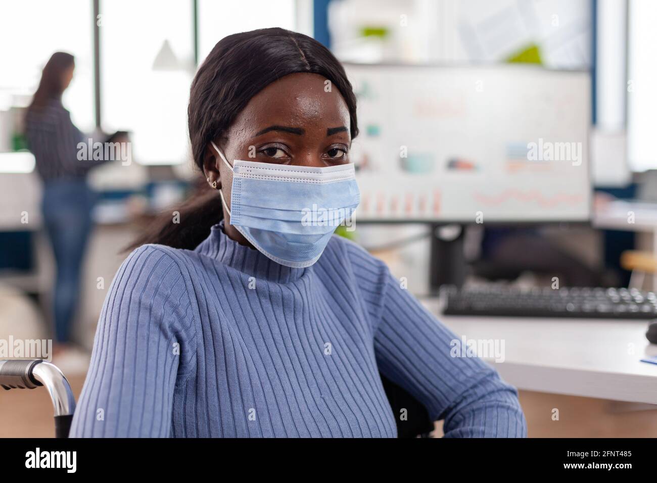 Disabled woman wheelchair wearing face mask hi-res stock photography ...
