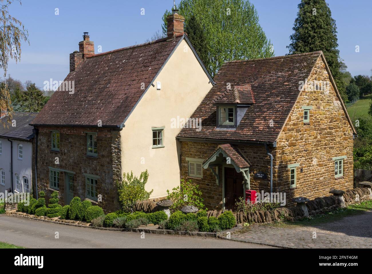 Attractive stone built houses overlooking the green in the village of ...