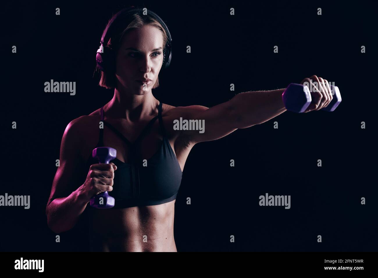 Caucasian strong woman with perfect abdomen and strong arms working out ...