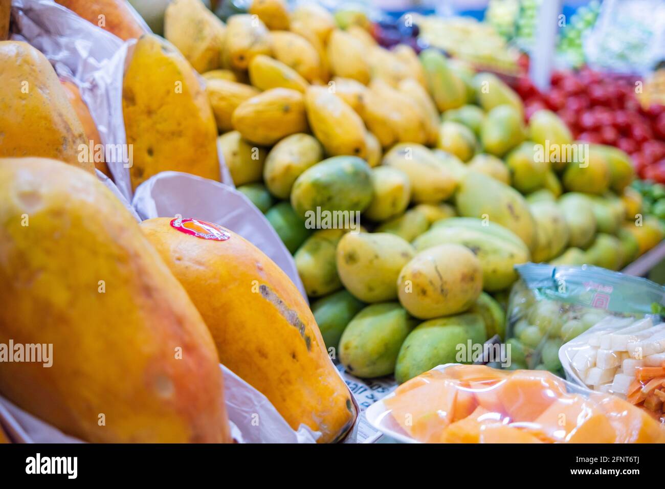Colorful fruit stand with fresh papayas, mangoes and more Stock Photo ...