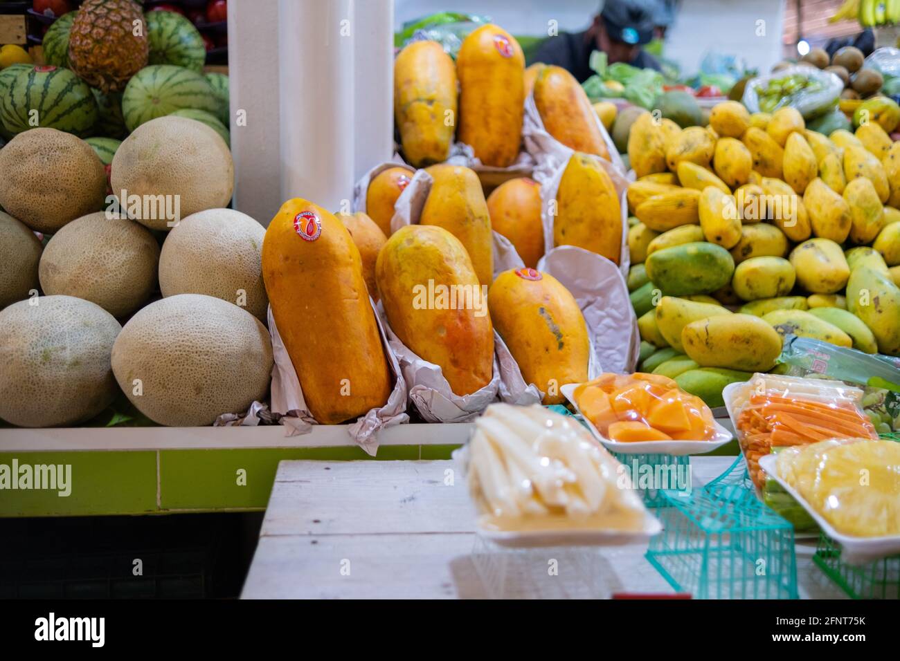 Colorful fruit stand with papayas, melons, and mangoes Stock Photo - Alamy