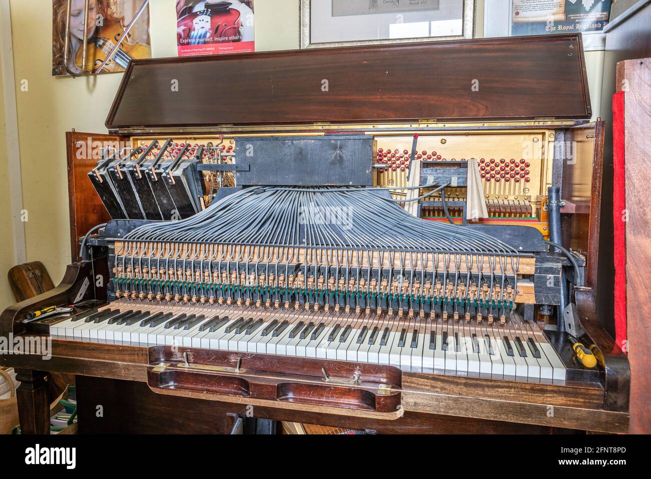 A pianola with the workings reversed to show the interior of the ...