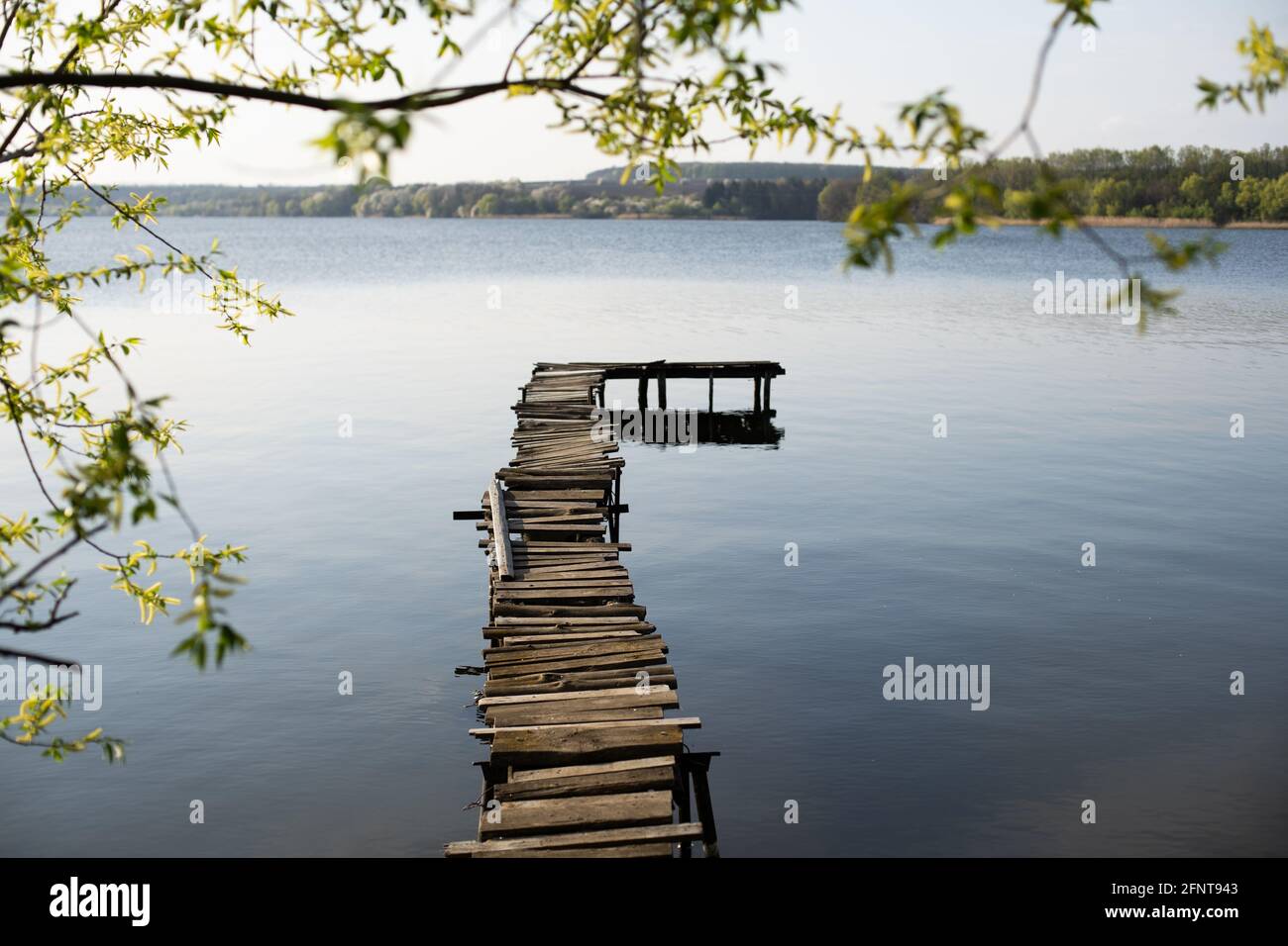The shore of the river with little bridge fisherman Stock Photo - Alamy