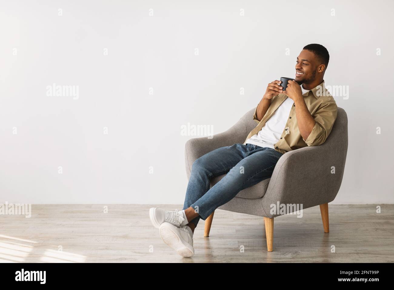 Relaxed man sitting in armchair hi-res stock photography and images - Alamy