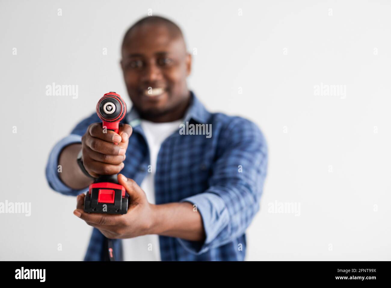 African american builder working with construction tools, holding ...