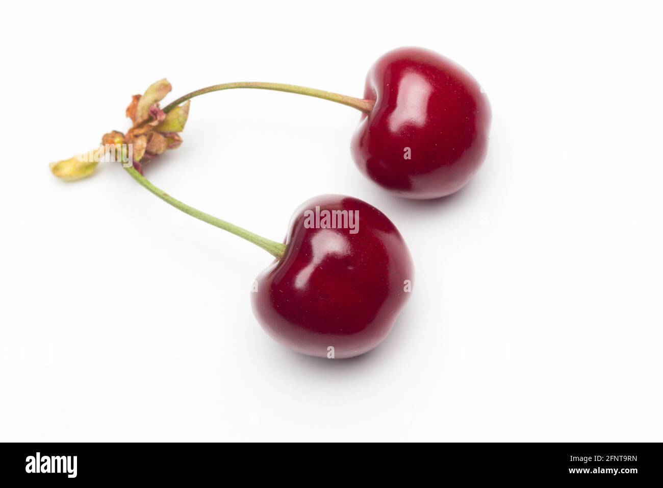 set of small red cherries on a white background full of vitamins and ...