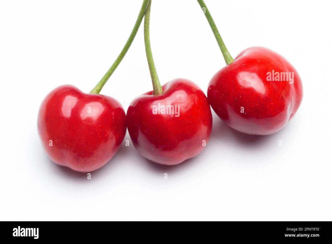 set of small red cherries on a white background full of vitamins and ...