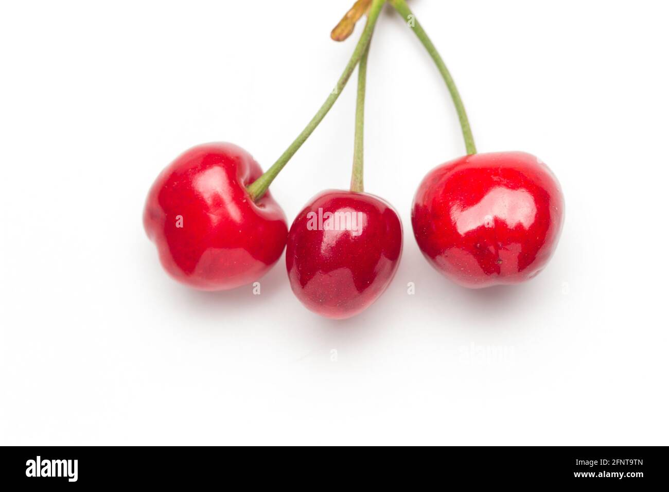set of small red cherries on a white background full of vitamins and ...
