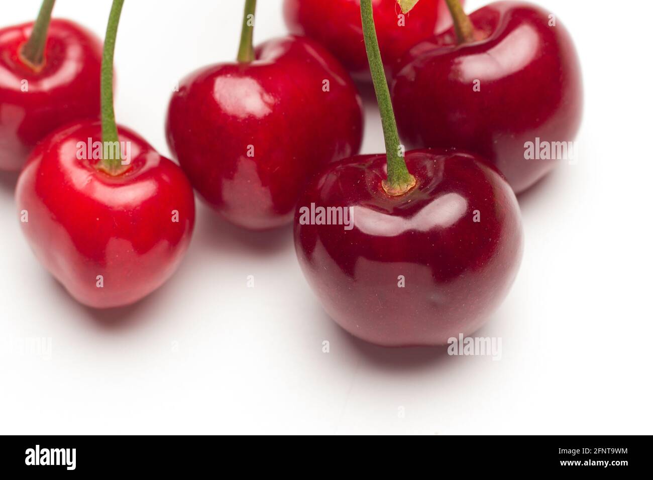 set of small red cherries on a white background full of vitamins and ...