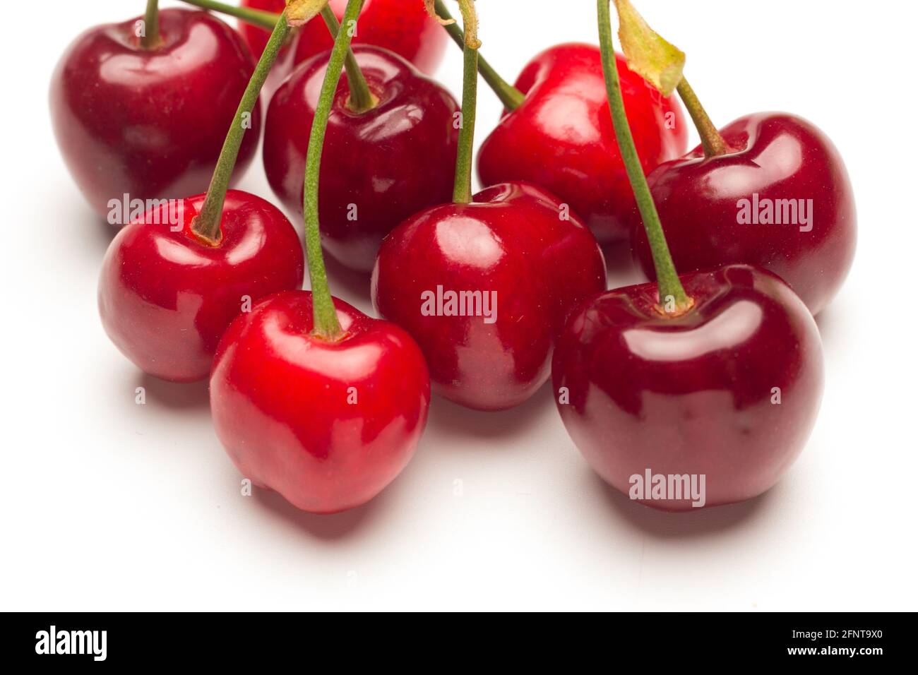 set of small red cherries on a white background full of vitamins and ...