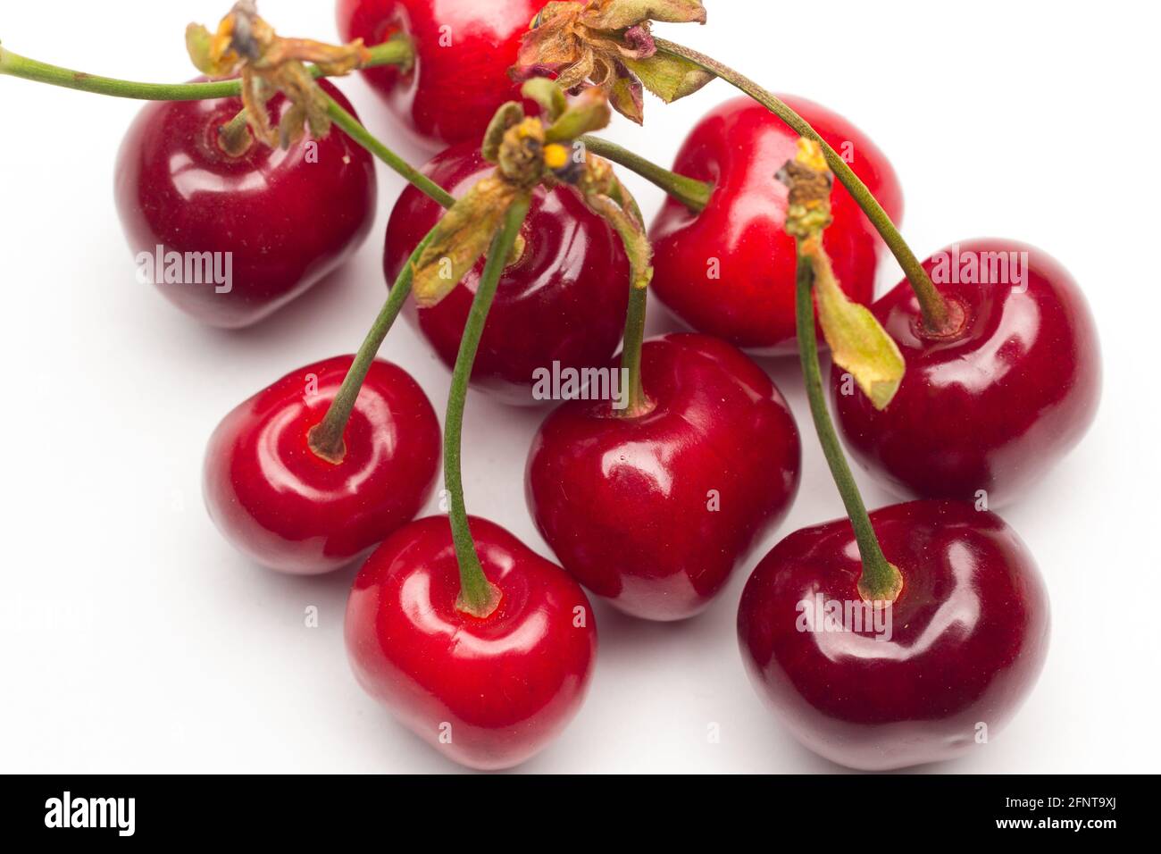 set of small red cherries on a white background full of vitamins and ...