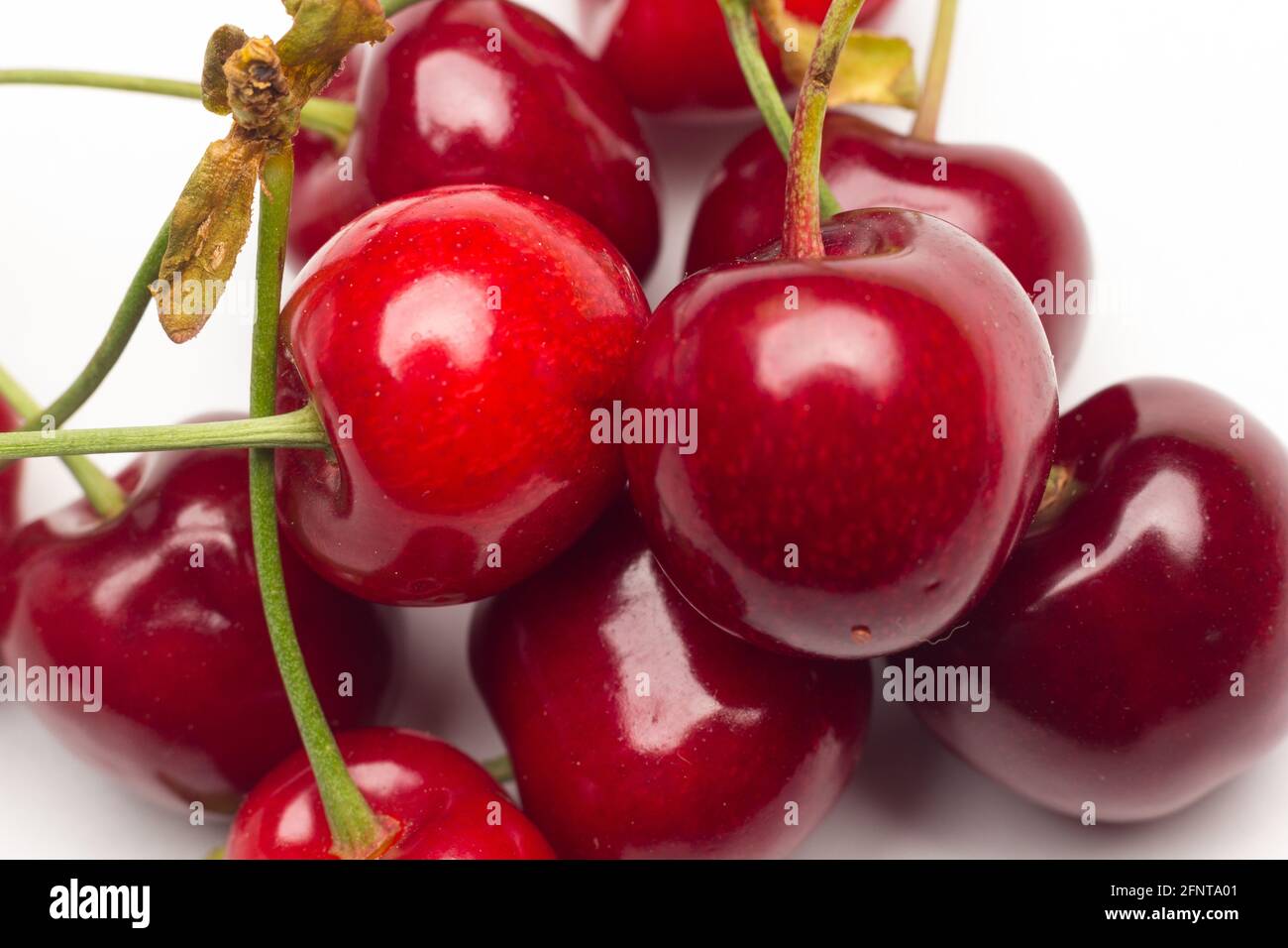 set of small red cherries on a white background full of vitamins and ...