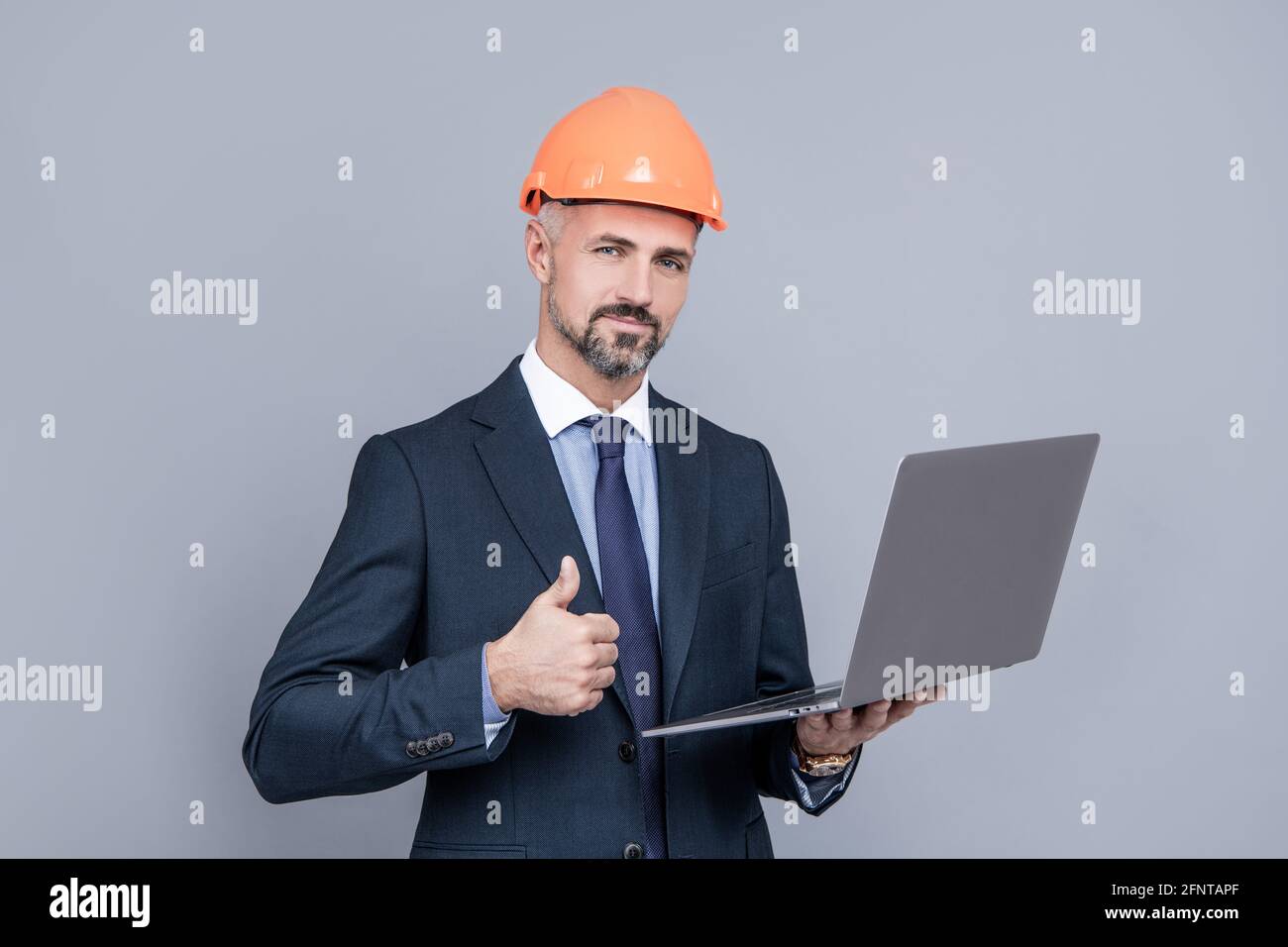 thumb up. agile business success. entrepreneur in helmet use pc ...