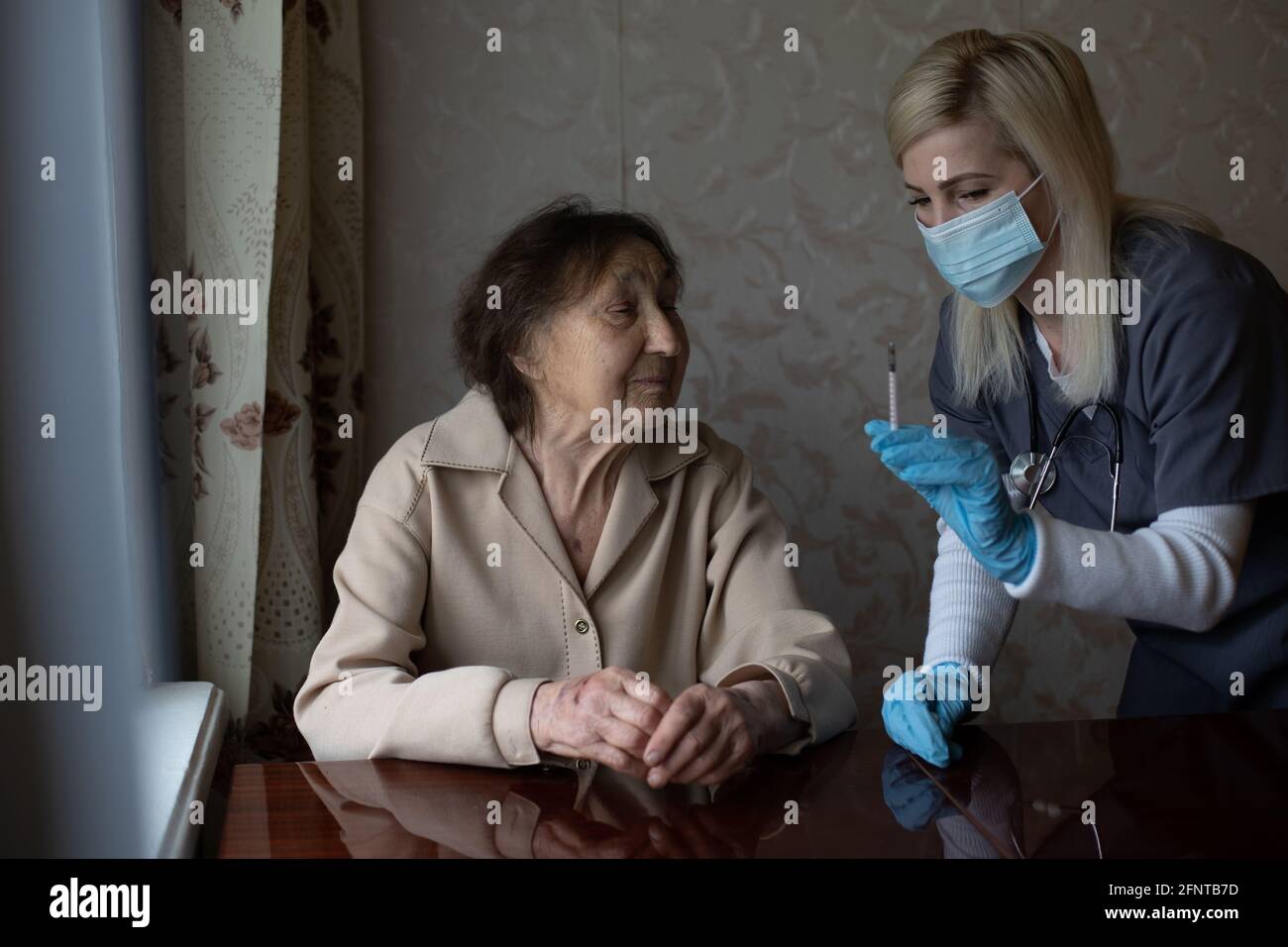 Nurse giving an injection to senior woman Stock Photo - Alamy
