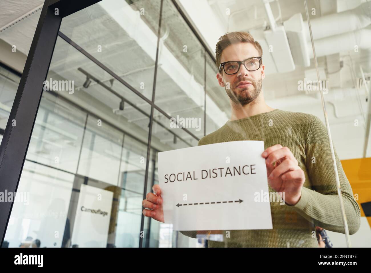 Responsible worker enforcing social distance rules at workplace Stock ...