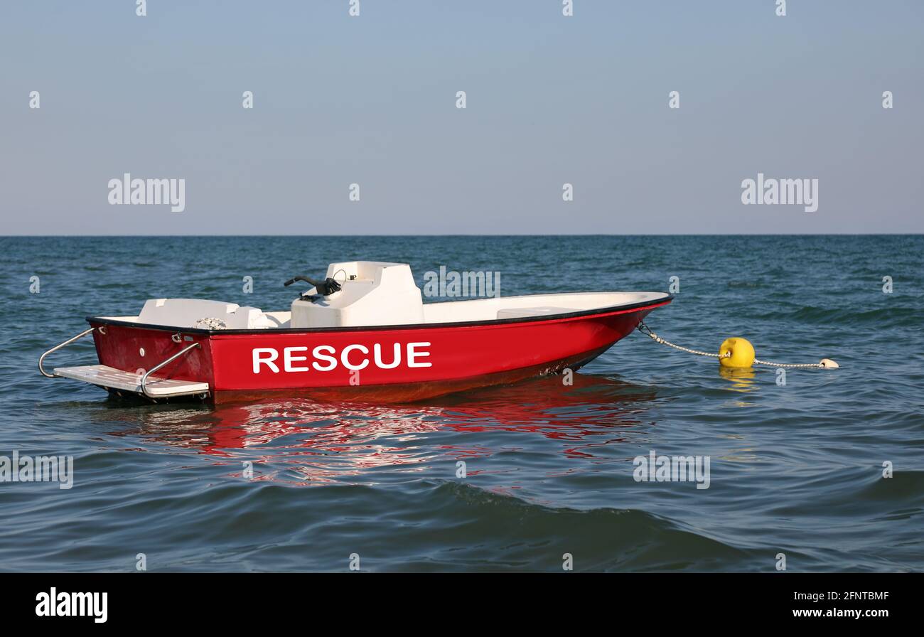 red motorboat in the middle of the sea to rescue swimmers with the ...