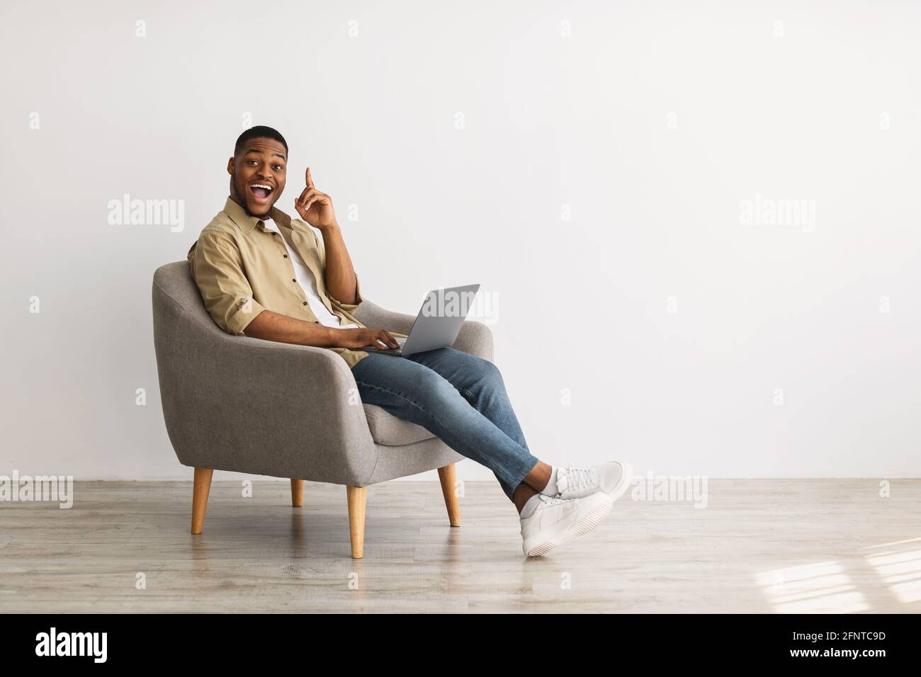 Black Guy With Laptop Having Idea Sitting In Chair Indoor Stock Photo ...