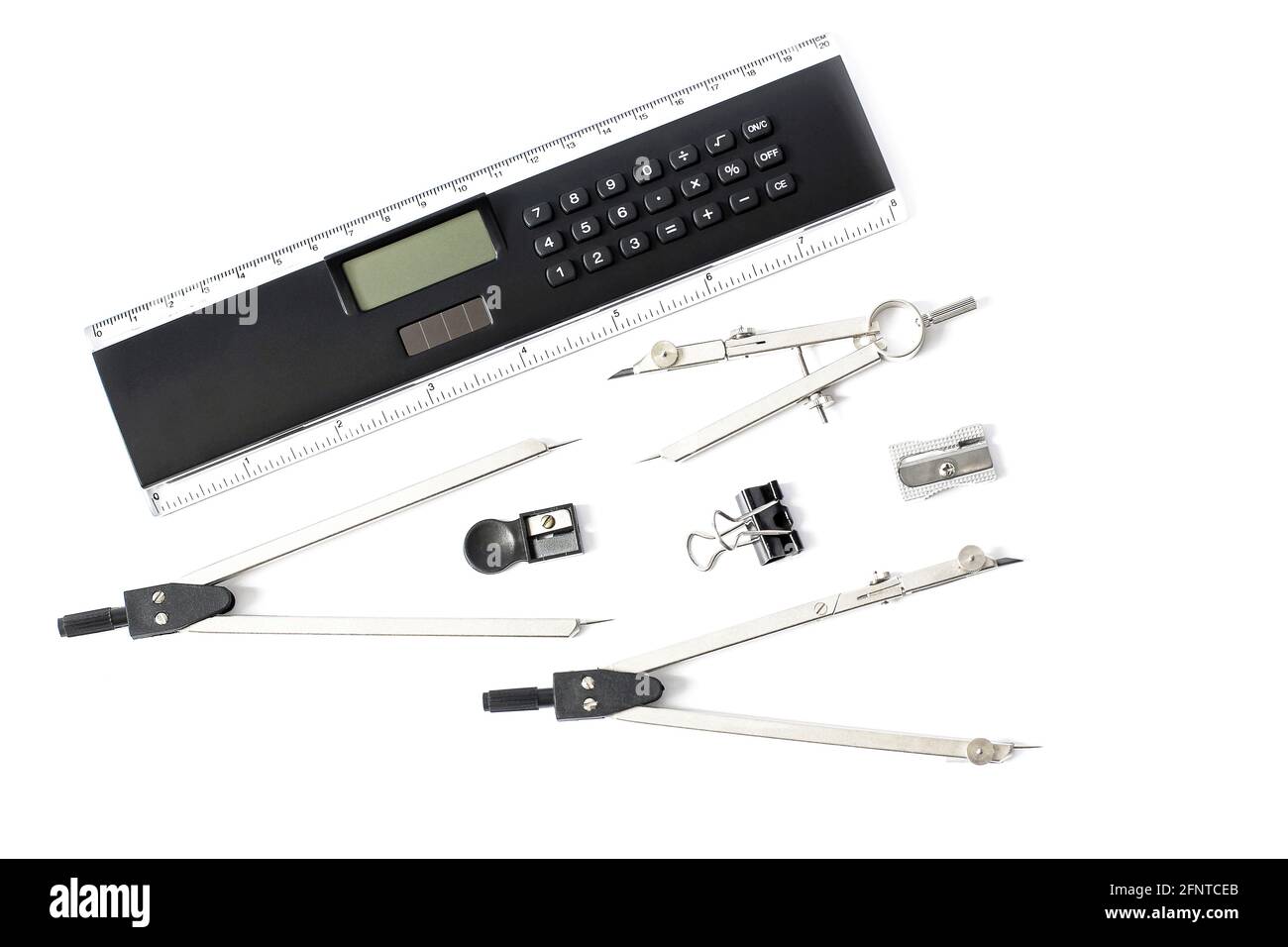 Divider, ruler, calculator, sharpener. Office supplies on a white ...