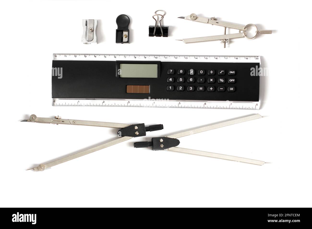 Divider, ruler, calculator, sharpener. Office supplies on a white ...