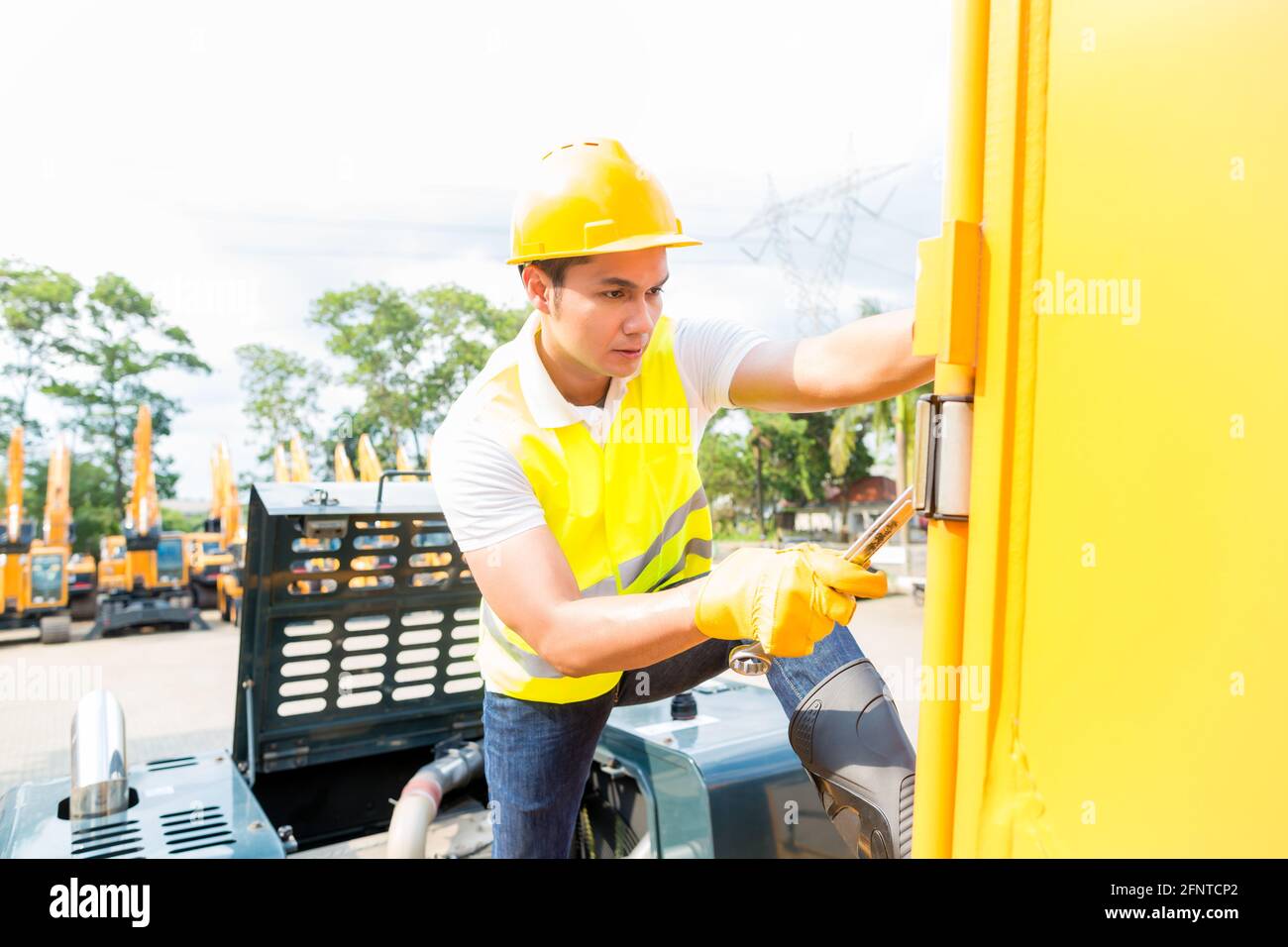 Asian engine mechanic engineer doing maintenance on machine Stock Photo ...